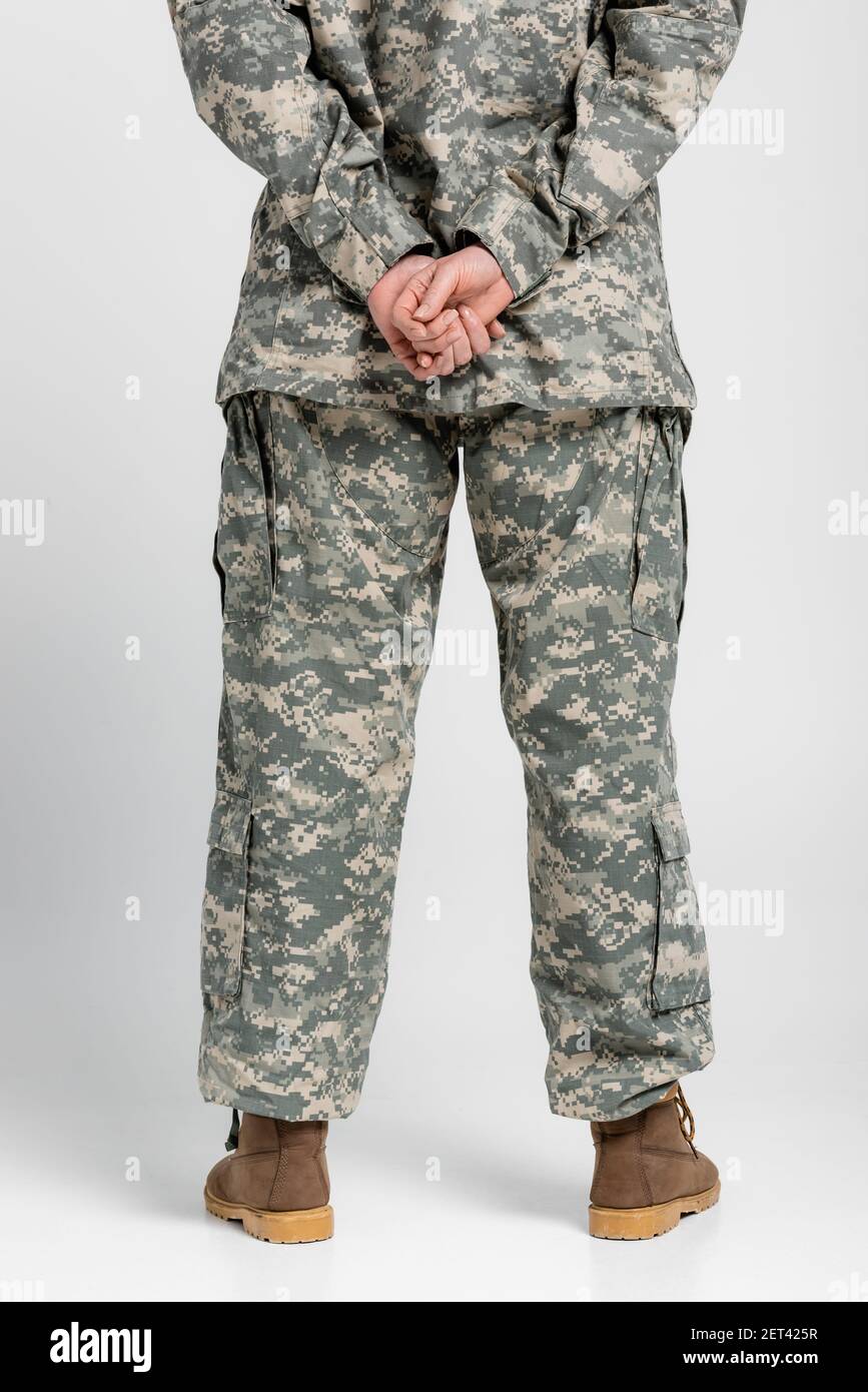 Back view of woman in military uniform on grey background Stock Photo ...