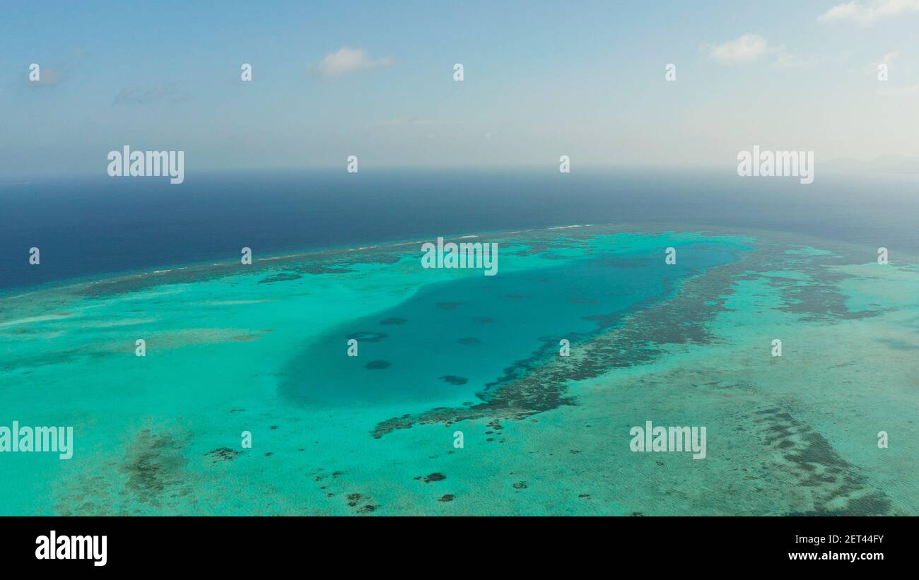 Tropical islands and coral atolls with blue water of the sea, aerial ...