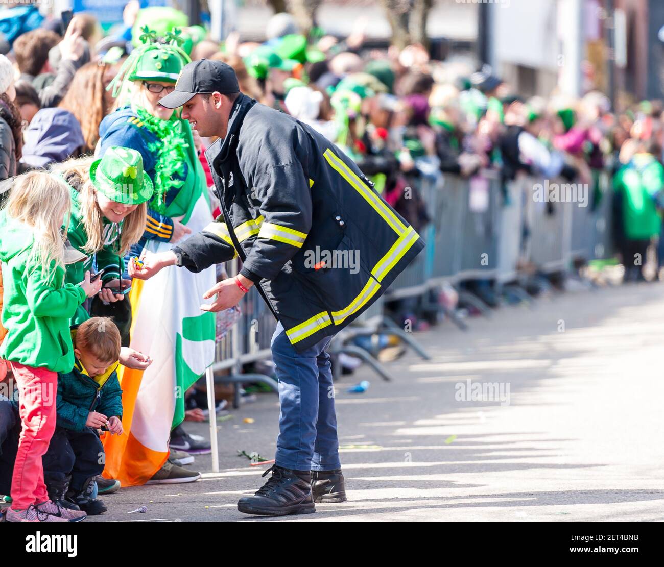 Firefighter giving trinkets to the crowd behind the fence at the 2019 ...