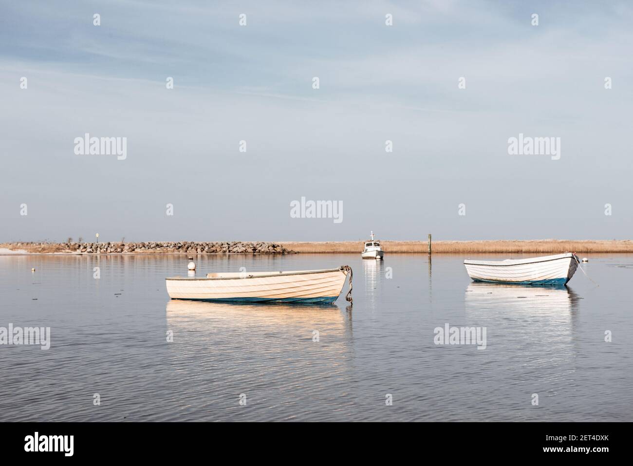 Dramatic photo of fishing boats in harbor in calm sunset light Stock ...