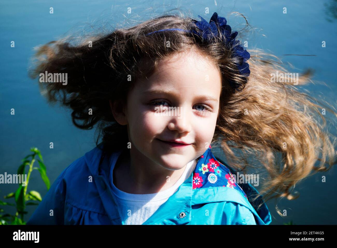 Portrait of a smiling girl spinning around with flowing hair, Italy ...