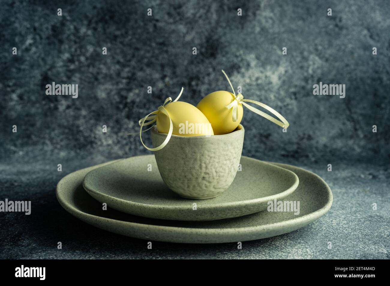 Two Easter eggs in a ceramic bowl arrangement Stock Photo - Alamy