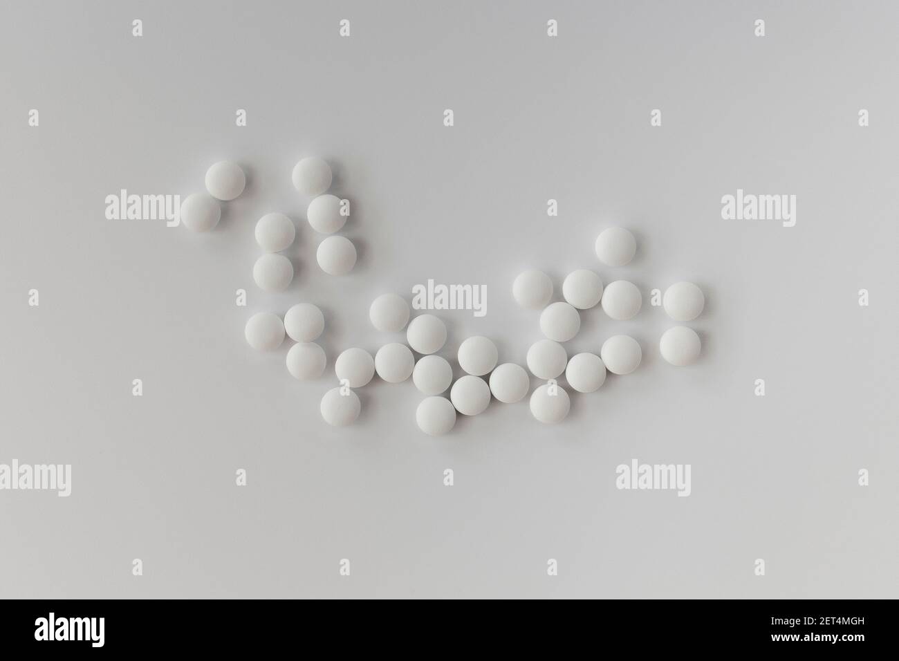 topview of melatonin tablets on a white creamy surface. dietary concept ...