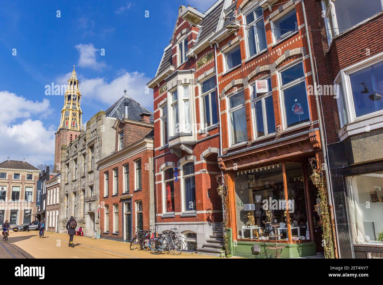 Street with historic houses and church tower in Groningen, Netherlands ...