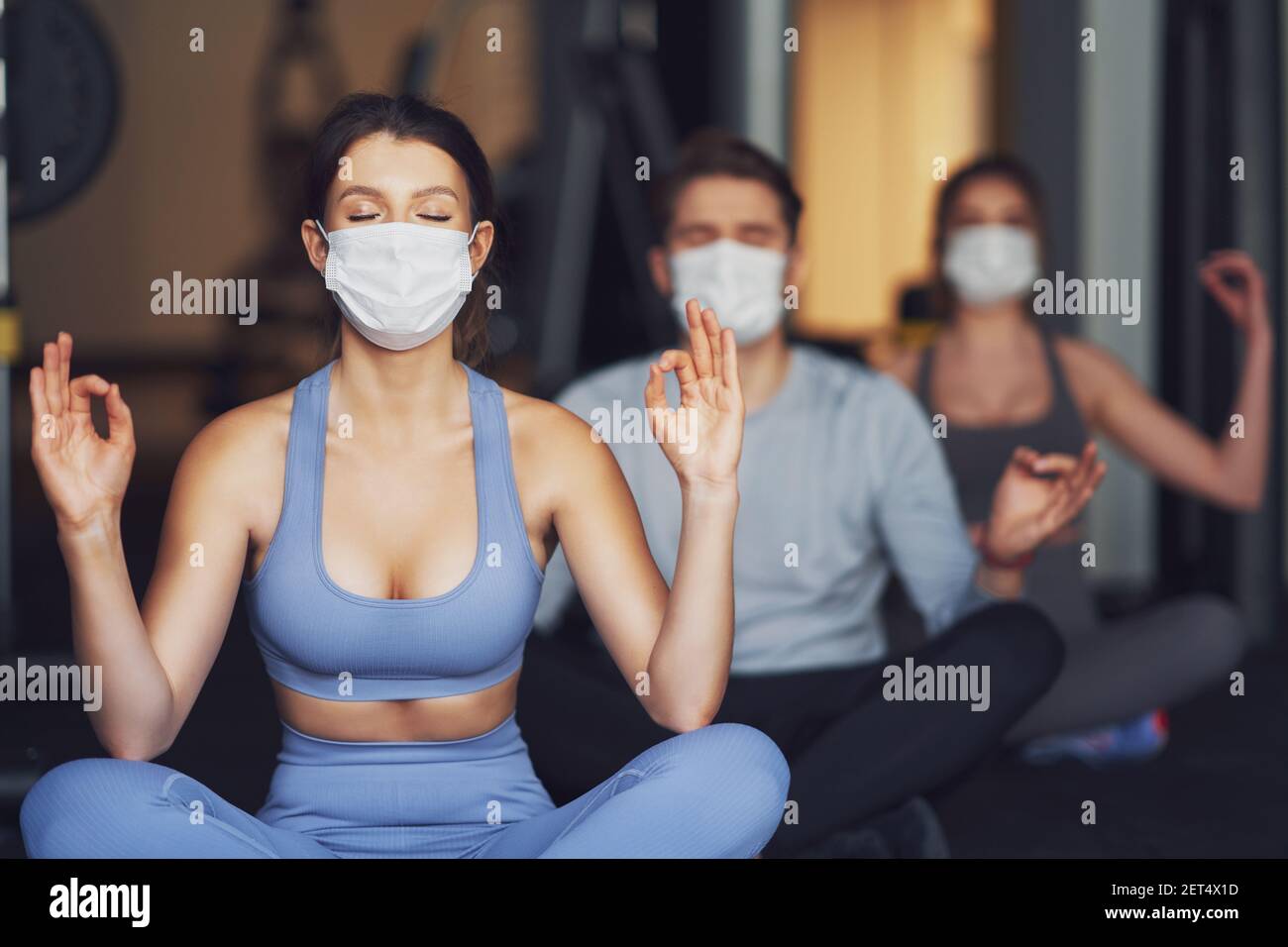 Group of people wearing masks working out in a gym Stock Photo - Alamy