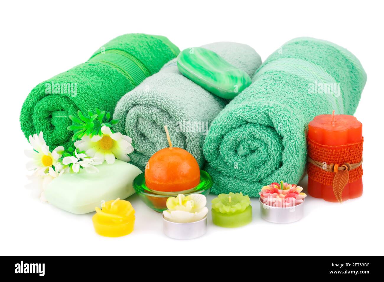 Spa set with towels, candles, soaps and flowers isolated on white ...