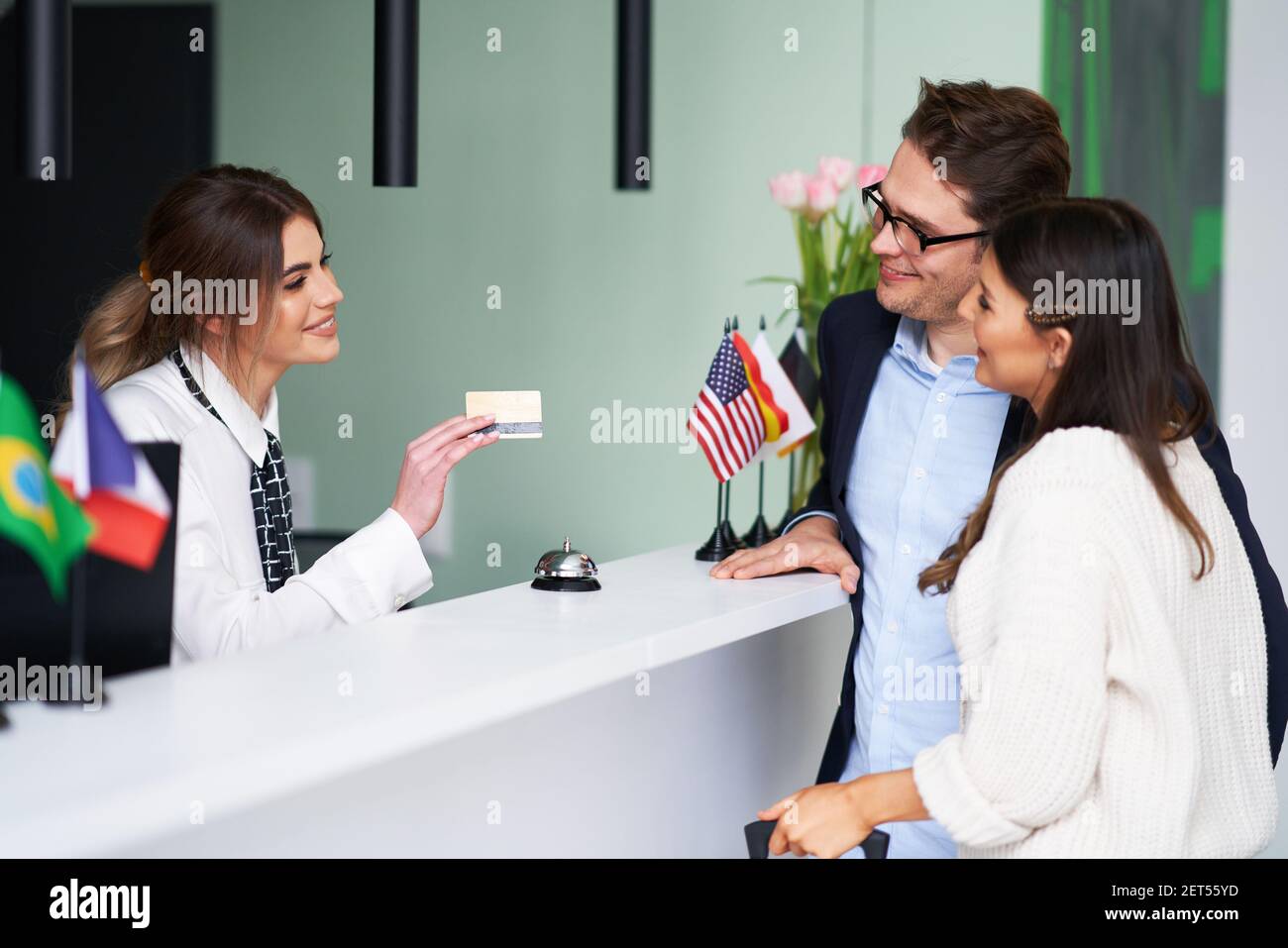 Adult couple checking-in a hotel Stock Photo - Alamy