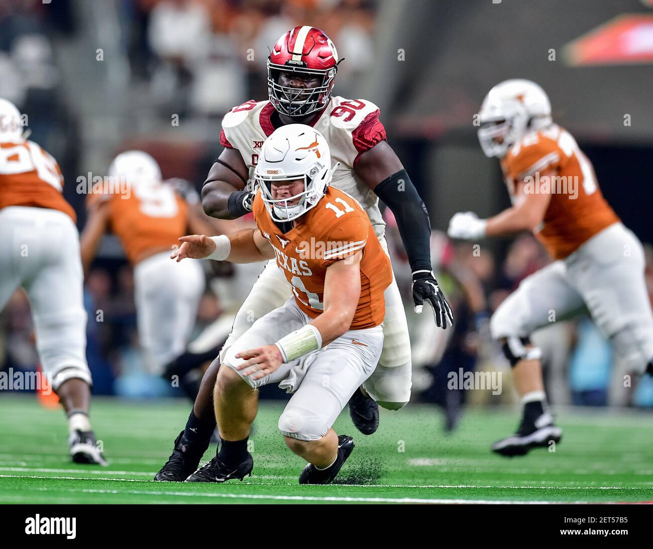 Texas Longhorns quarterback Sam Ehlinger (11) passes the ball as he is ...
