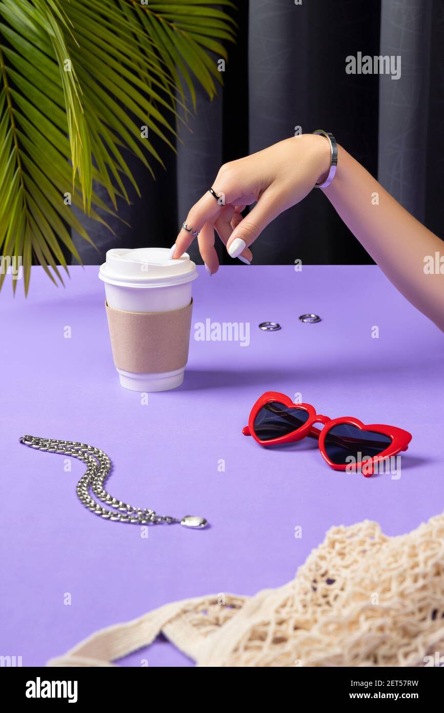 Beautiful groomed womans hand with paper coffee cup. Female summer ...