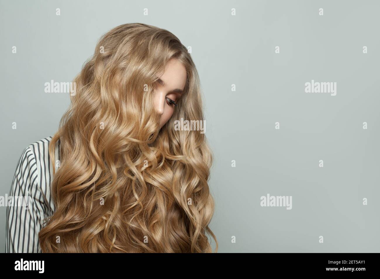 Blonde woman with long perfect hair on white background Stock Photo - Alamy
