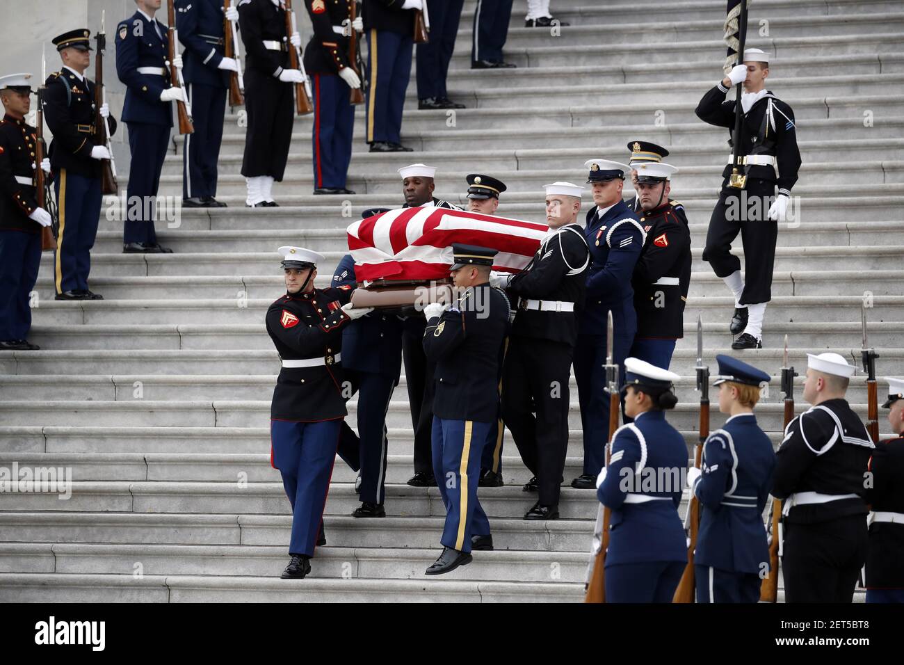 The flag-draped casket of former President George H.W. Bush is carried ...