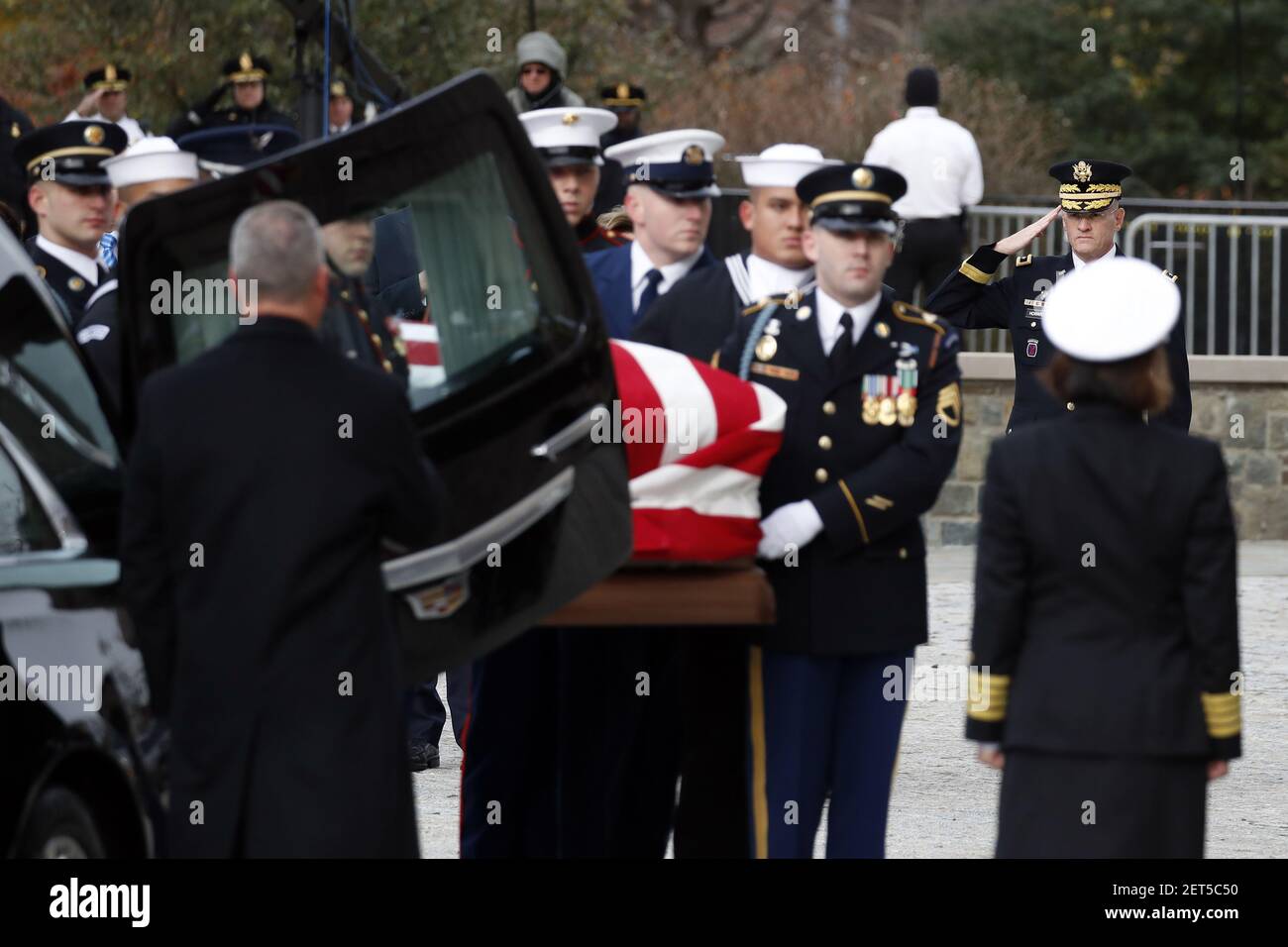 The flag-draped casket of former President George H.W. Bush is carried ...