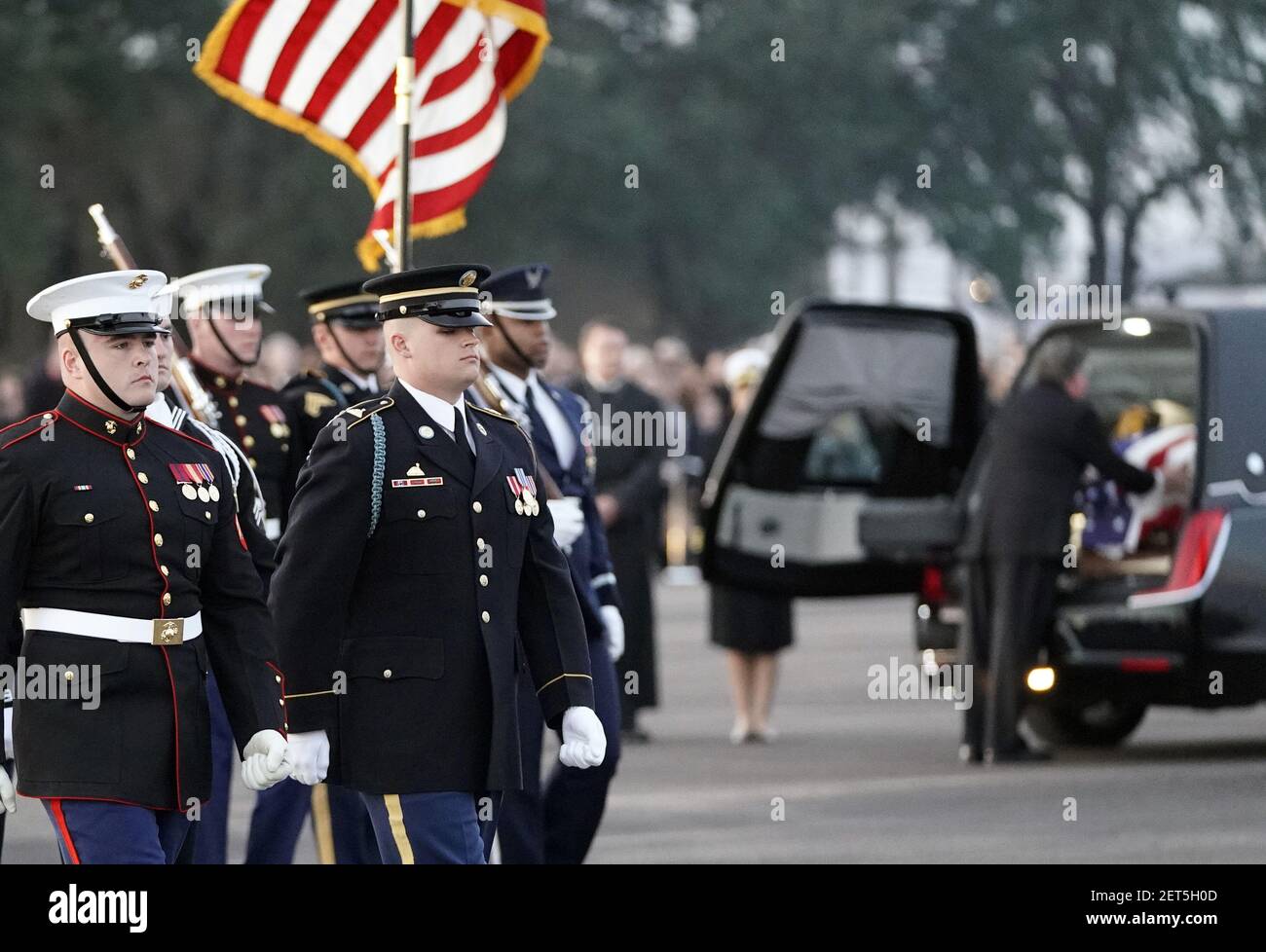 The flag-draped casket of former President George H.W. Bush is in a ...