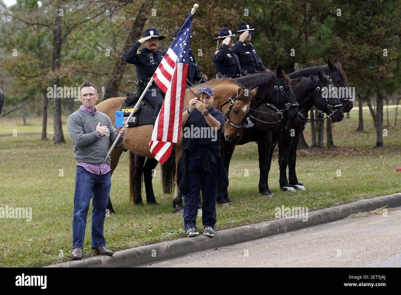 People line the road as the hearse carrying the flag-draped casket of ...
