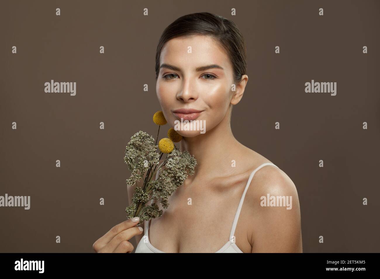 Herbal medicine concept. Beautiful young woman spa model with flowers ...