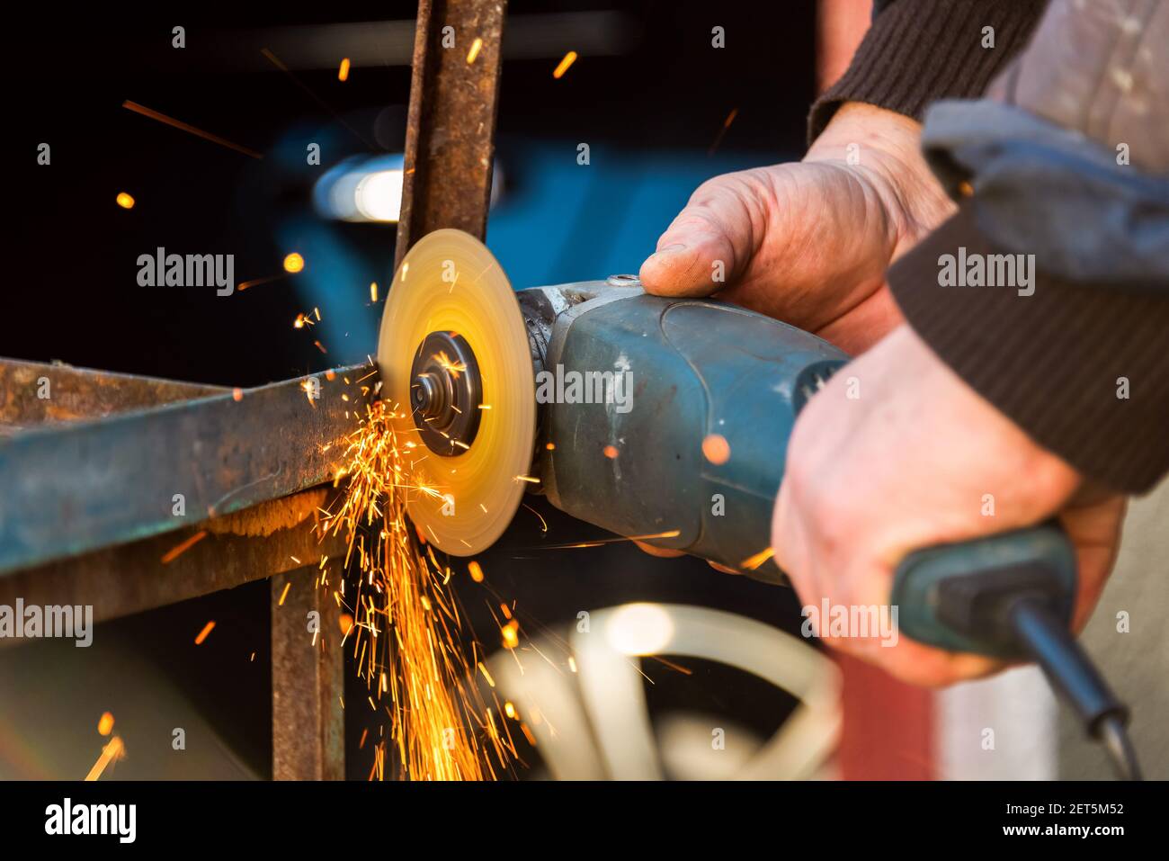 Man working with grinder saw, close up view on tool. Electric saw and ...