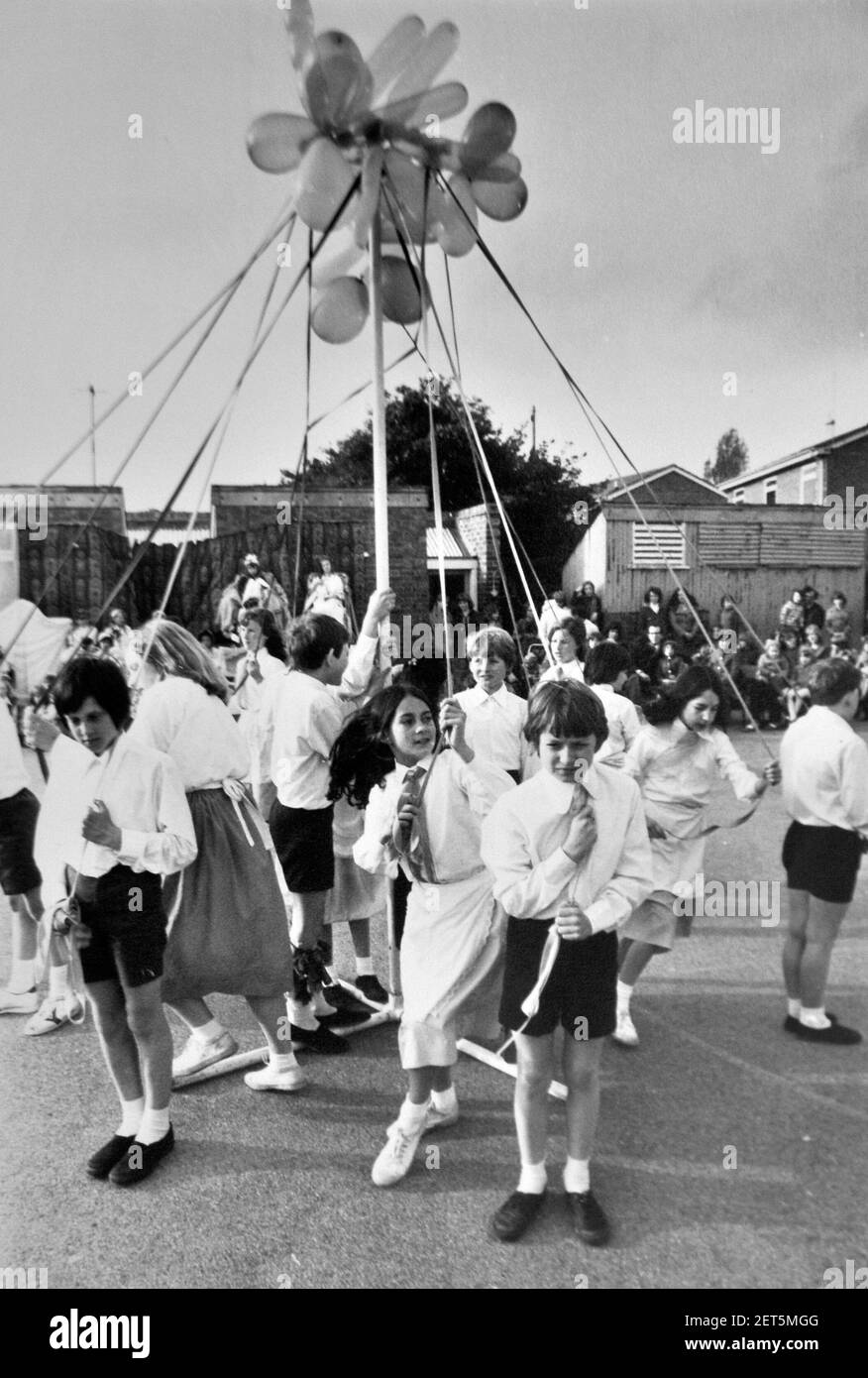 SCHOOL CHILDREN CELEBRATE MAY DAY BY DANCING ROUND THE MAYPOLE AT ...