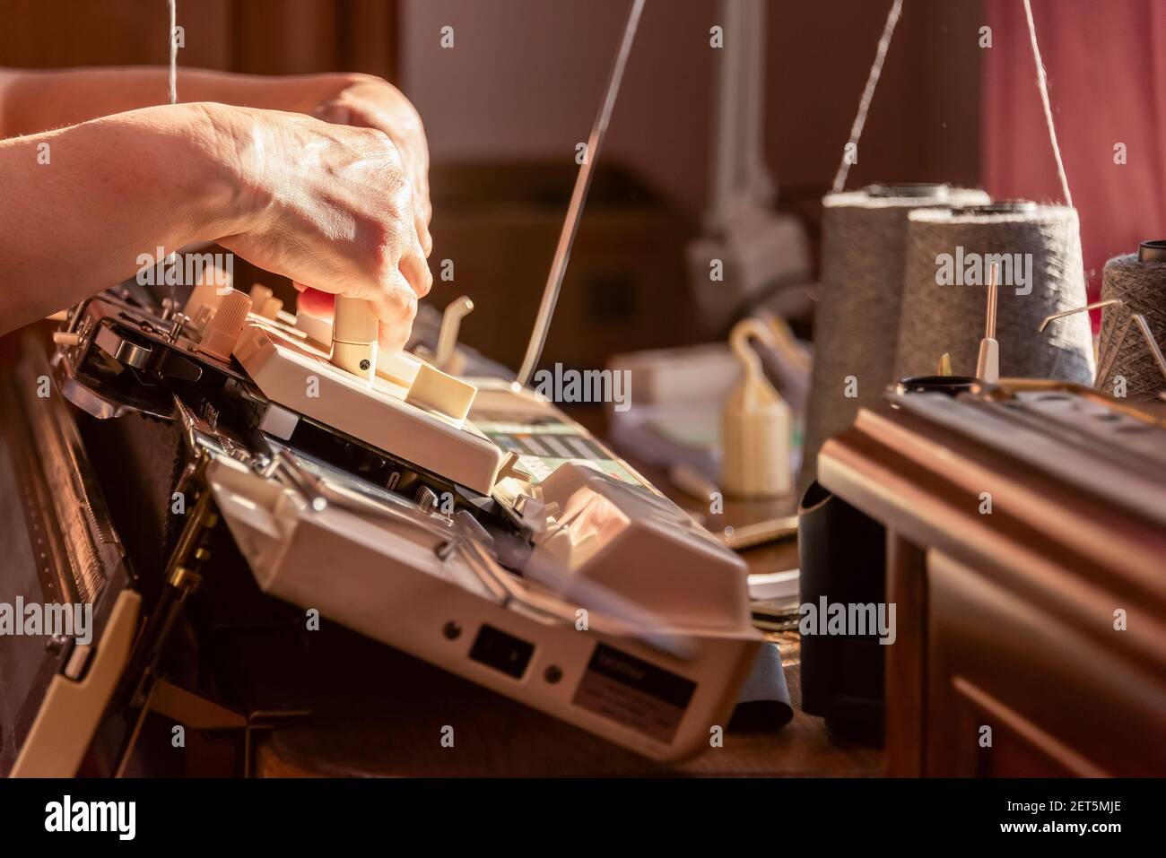 Womans hands working with knitting machine, knitting as womans hobbies ...