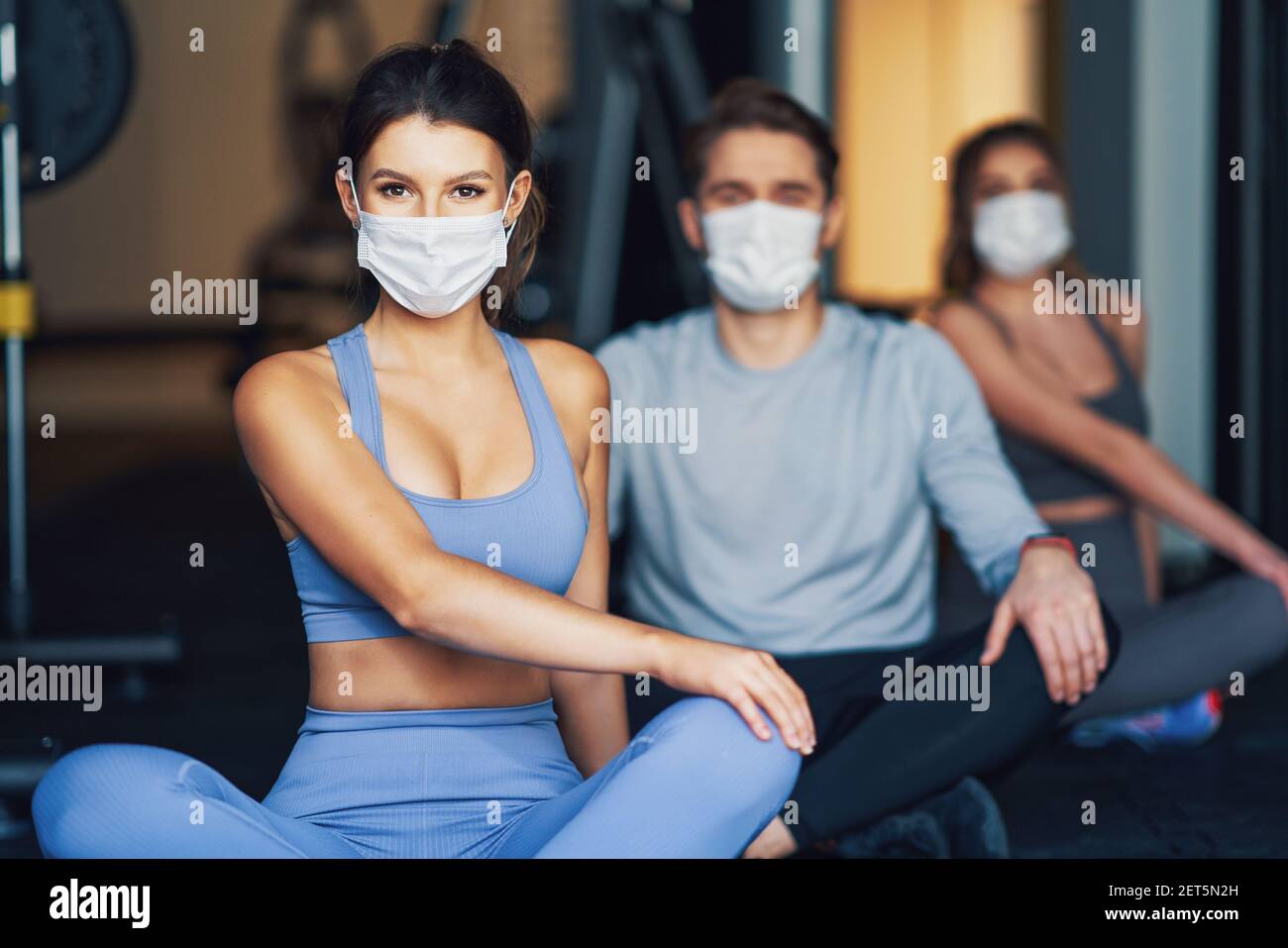 Group of people wearing masks working out in a gym Stock Photo - Alamy