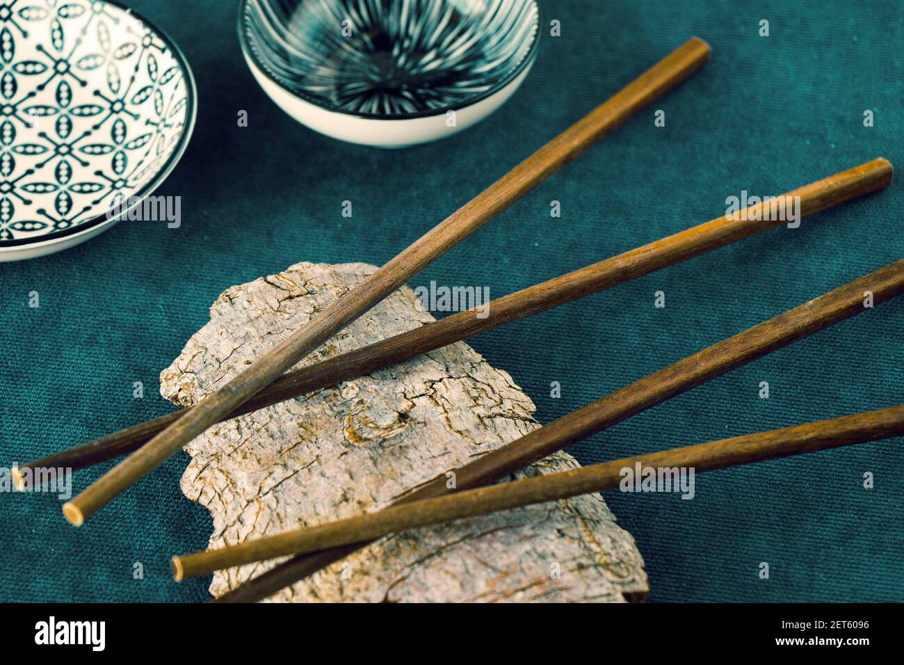 A set of empty Asian dishware with bowl and chopsticks on the blue ...