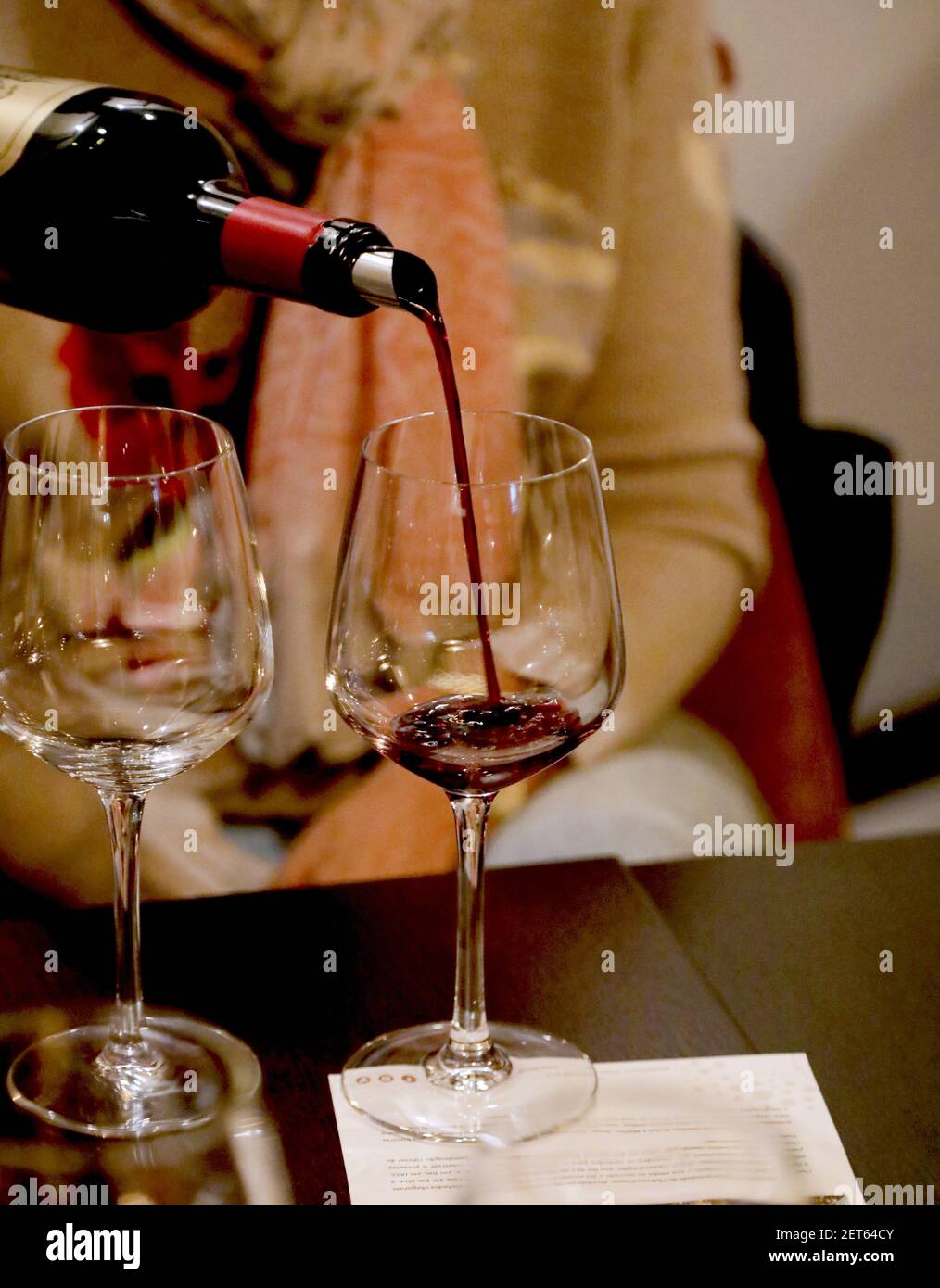 A vertical shot of pouring red wines in a restaurant Stock Photo - Alamy