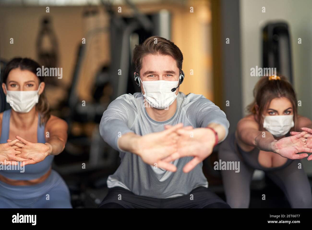 Group of people wearing masks working out in a gym Stock Photo - Alamy