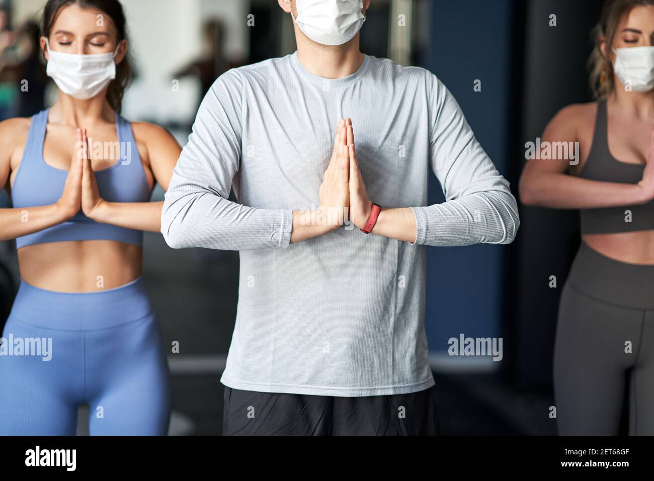 Group of people wearing masks working out in a gym Stock Photo - Alamy
