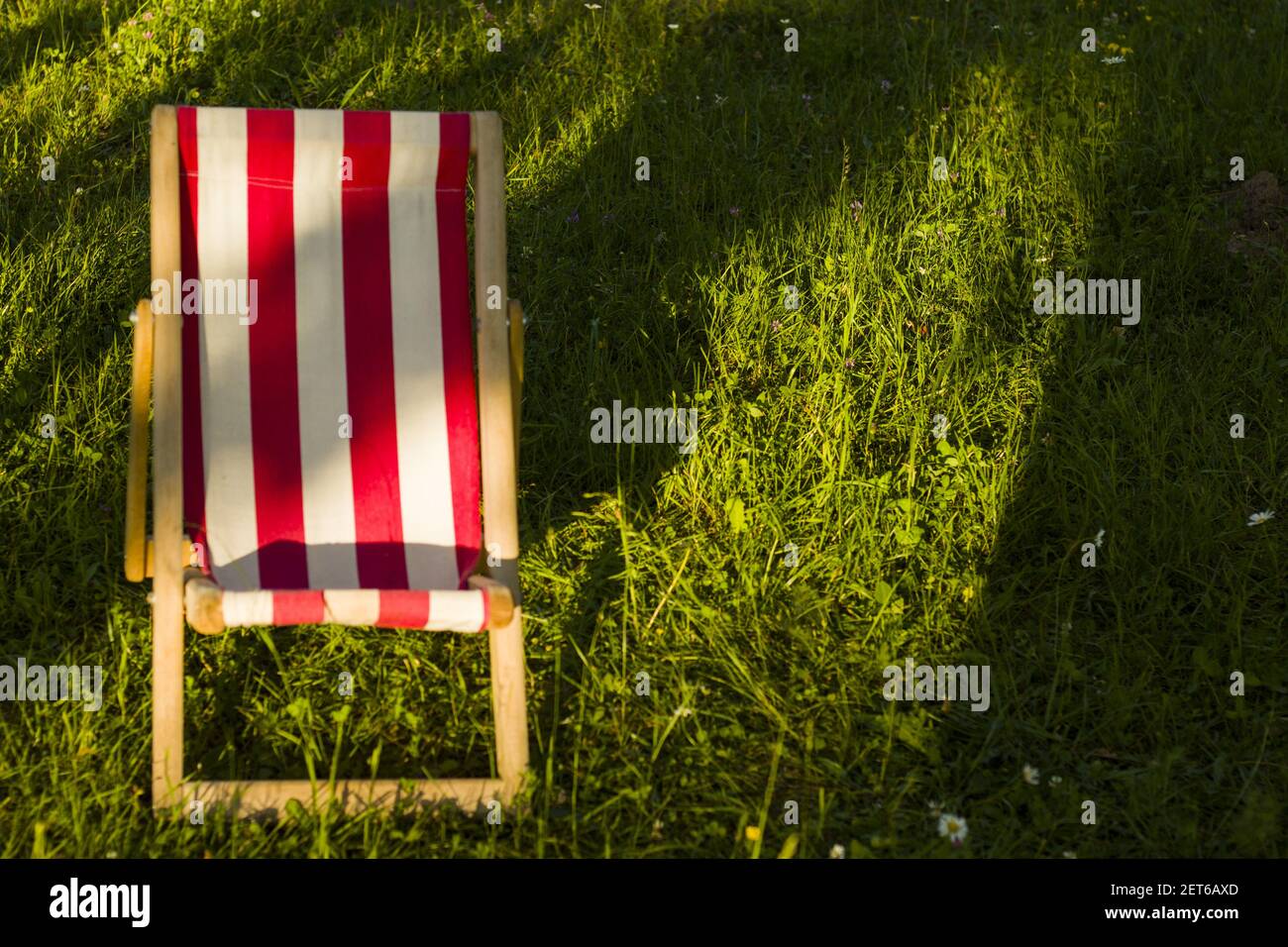 A yard chair on the grass, summer holiday background Stock Photo - Alamy