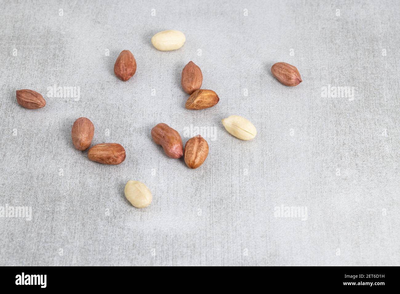 peanuts scattered on a gray background. Top view Stock Photo - Alamy