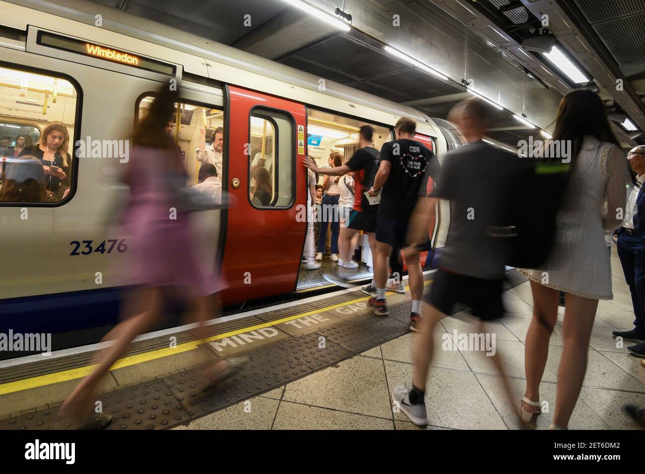 Random passenger people at the underground tube station tfl with moving ...