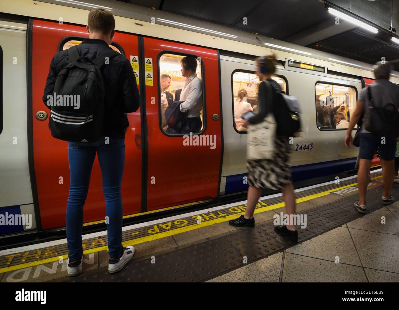 Random passenger people at the underground tube station tfl with moving ...