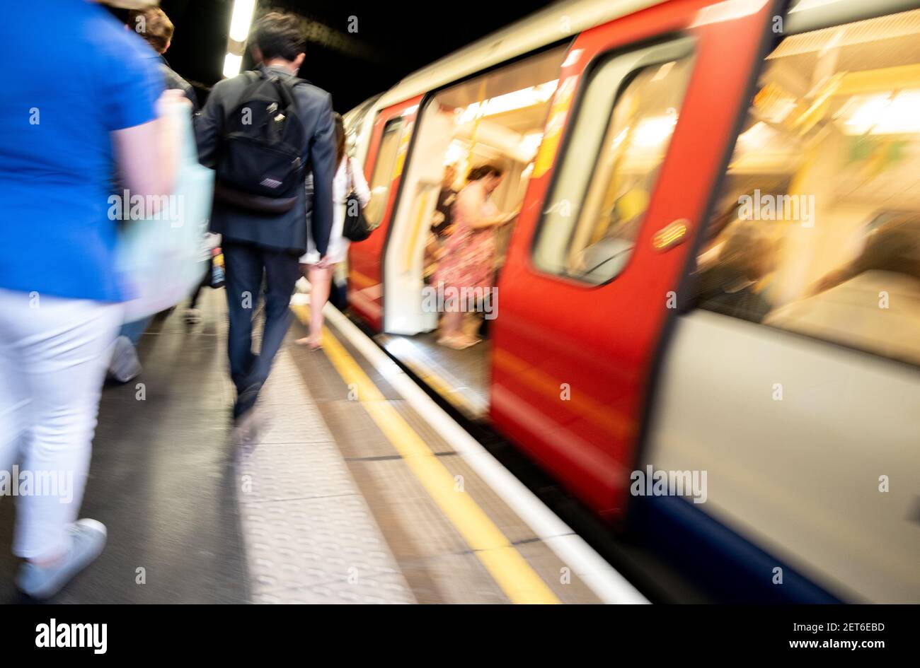 Random passenger people at the underground tube station tfl with moving ...