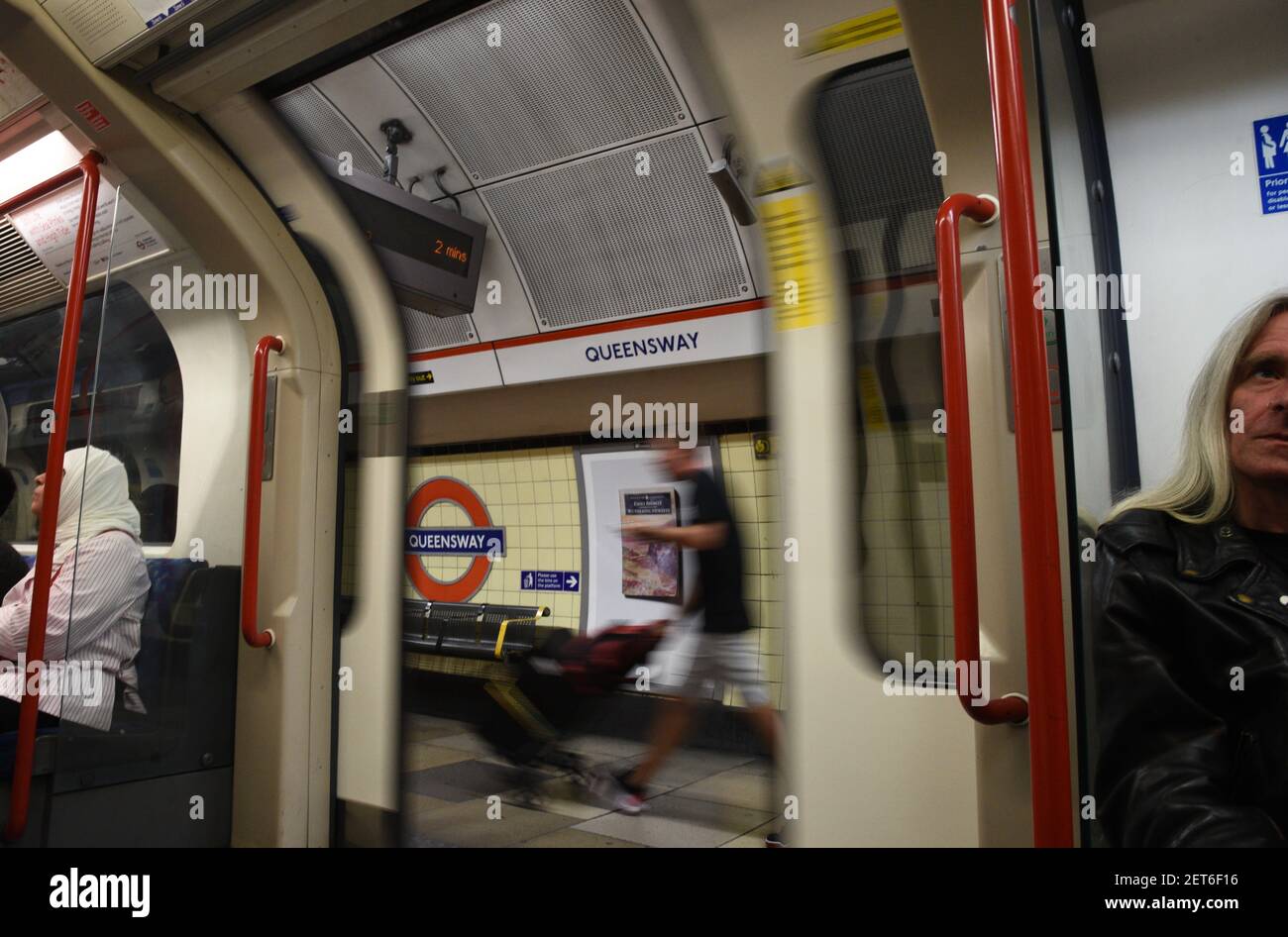 Random people at the underground tube station tfl with moving train ...