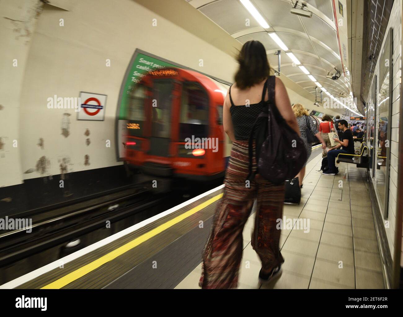 Random people at the underground tube station tfl with moving train ...