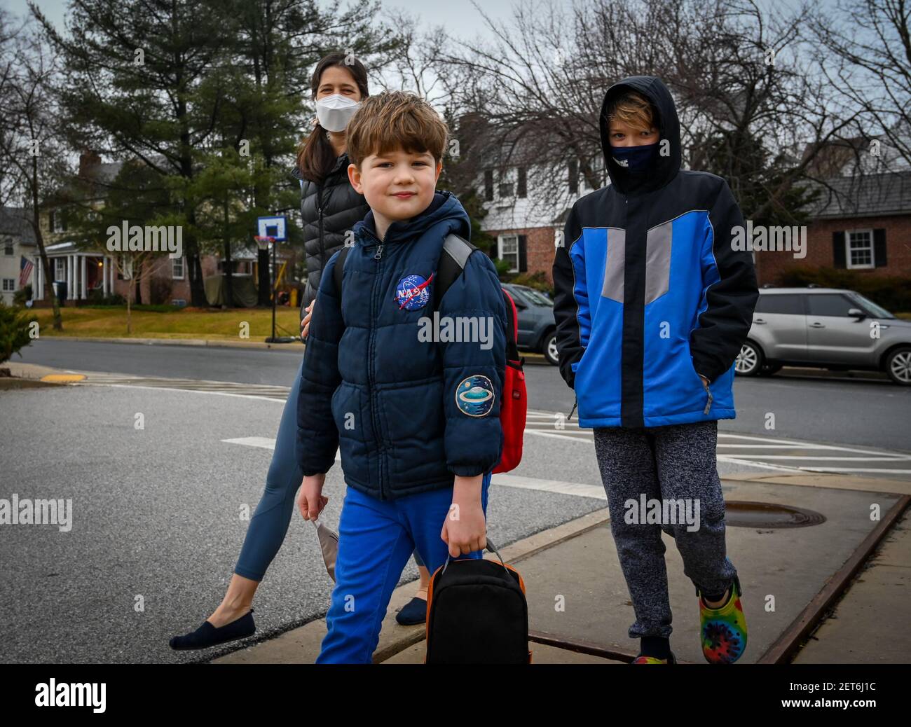 Cameron Burkhart, 6, walks with his mother Emma and brother Jude on his ...