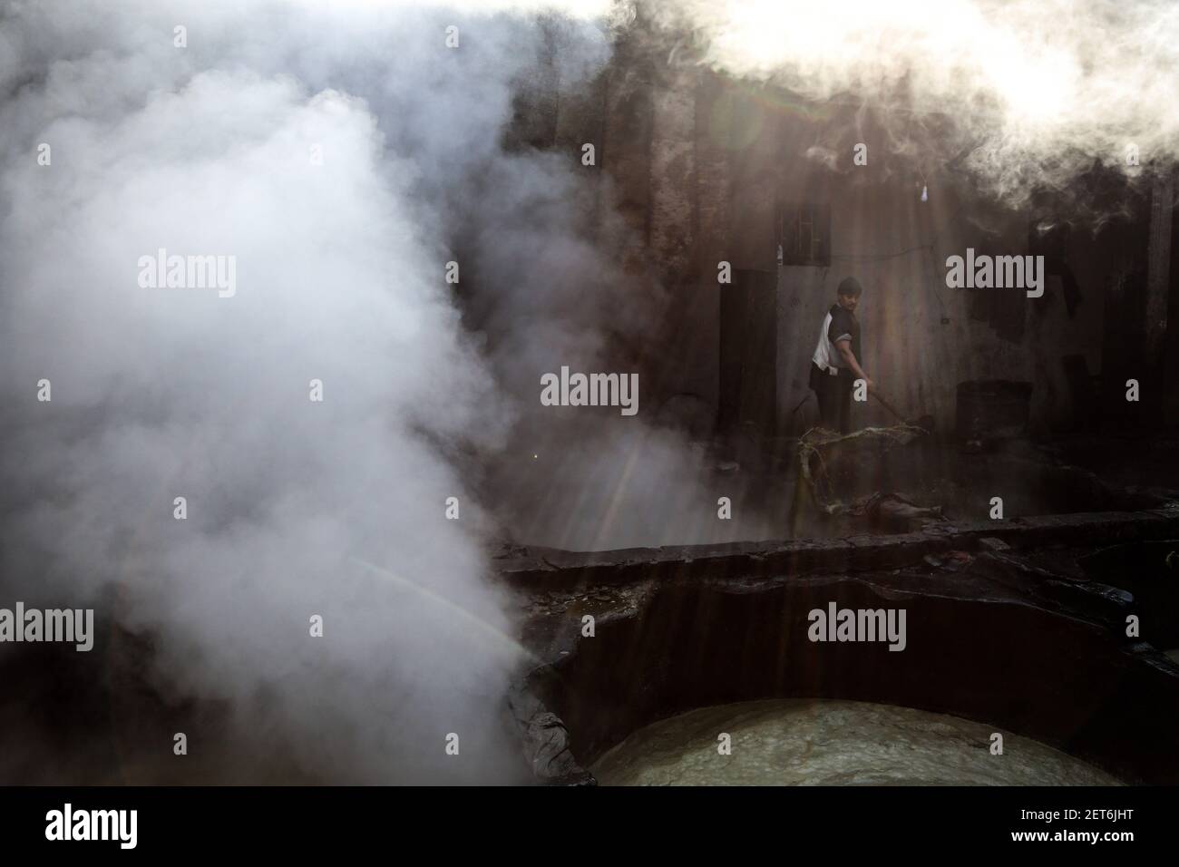 Mallawi, Egypt. 01st Mar, 2021. A worker cooks sugarcane molasses ...