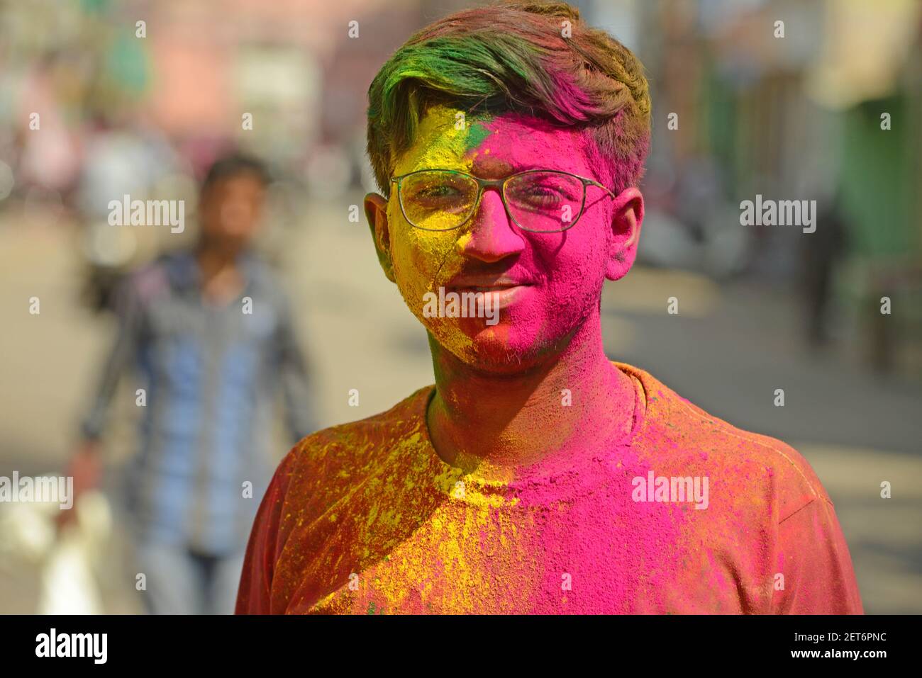 Portrait of Indian young man with full of colored powder on Holi, the ...