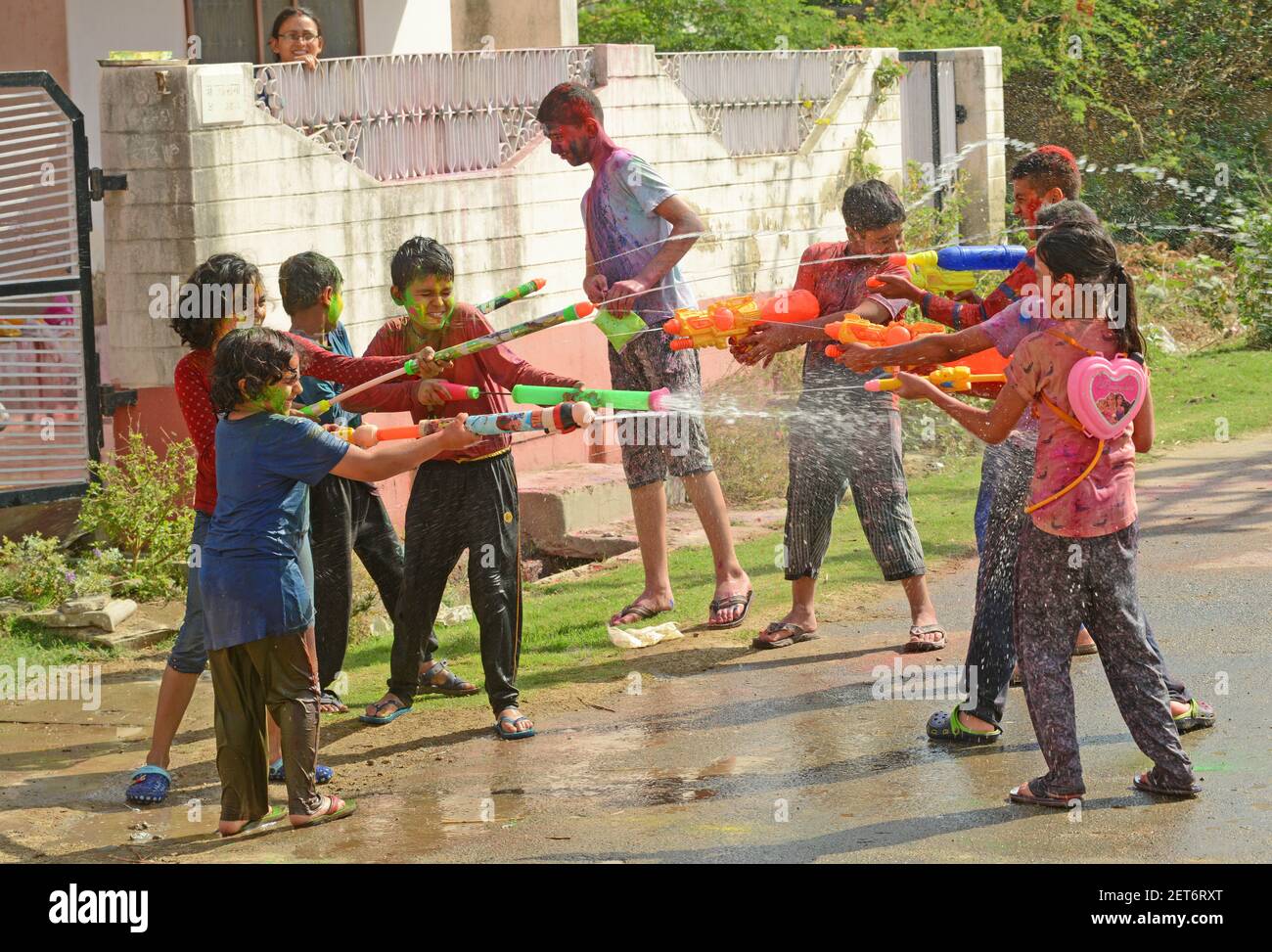 Children play with colors as they celebrate Holi, the spring festival ...