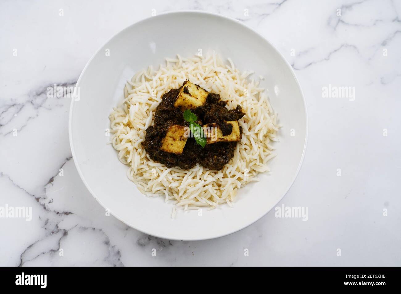 Palak Paneer or Saag Paneer with steamed basmati rice on white ...