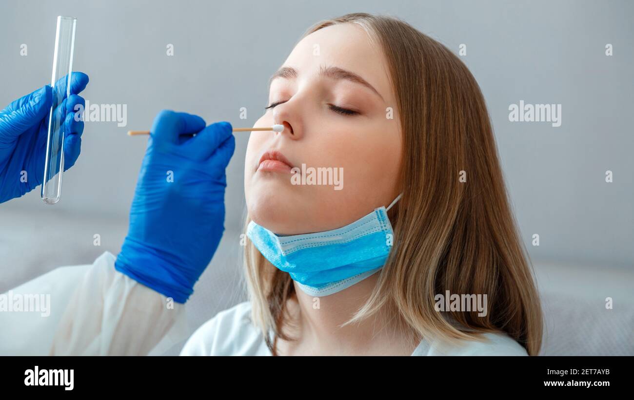 Doctor taking PCR test nasopharyngeal culture to woman patient. Nurse ...