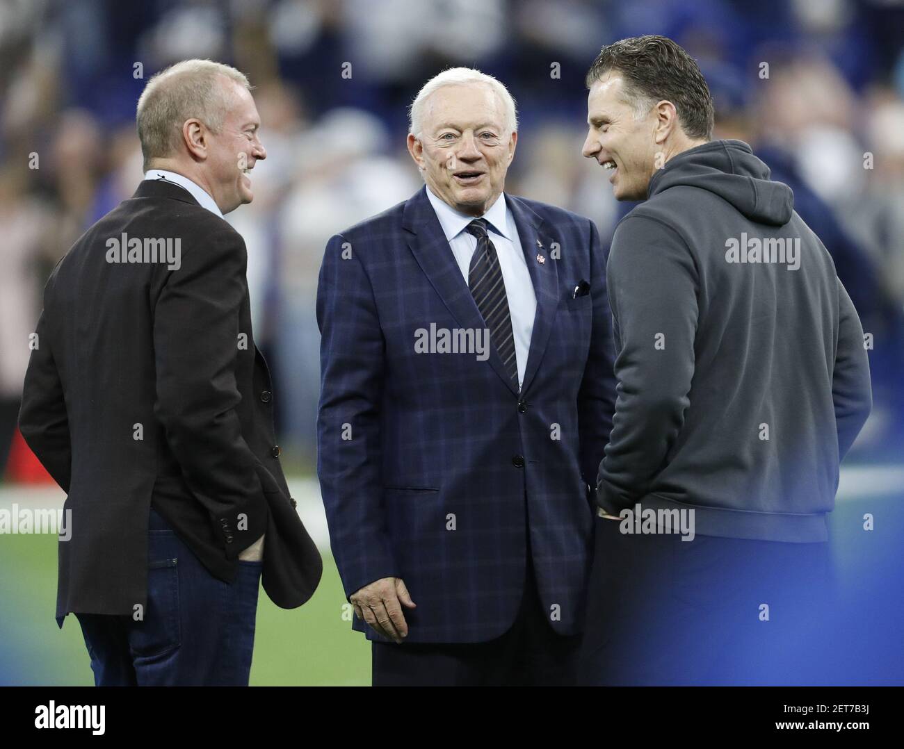 Dallas Cowboys owner Jimmy Johnson talks with friends on the field ...