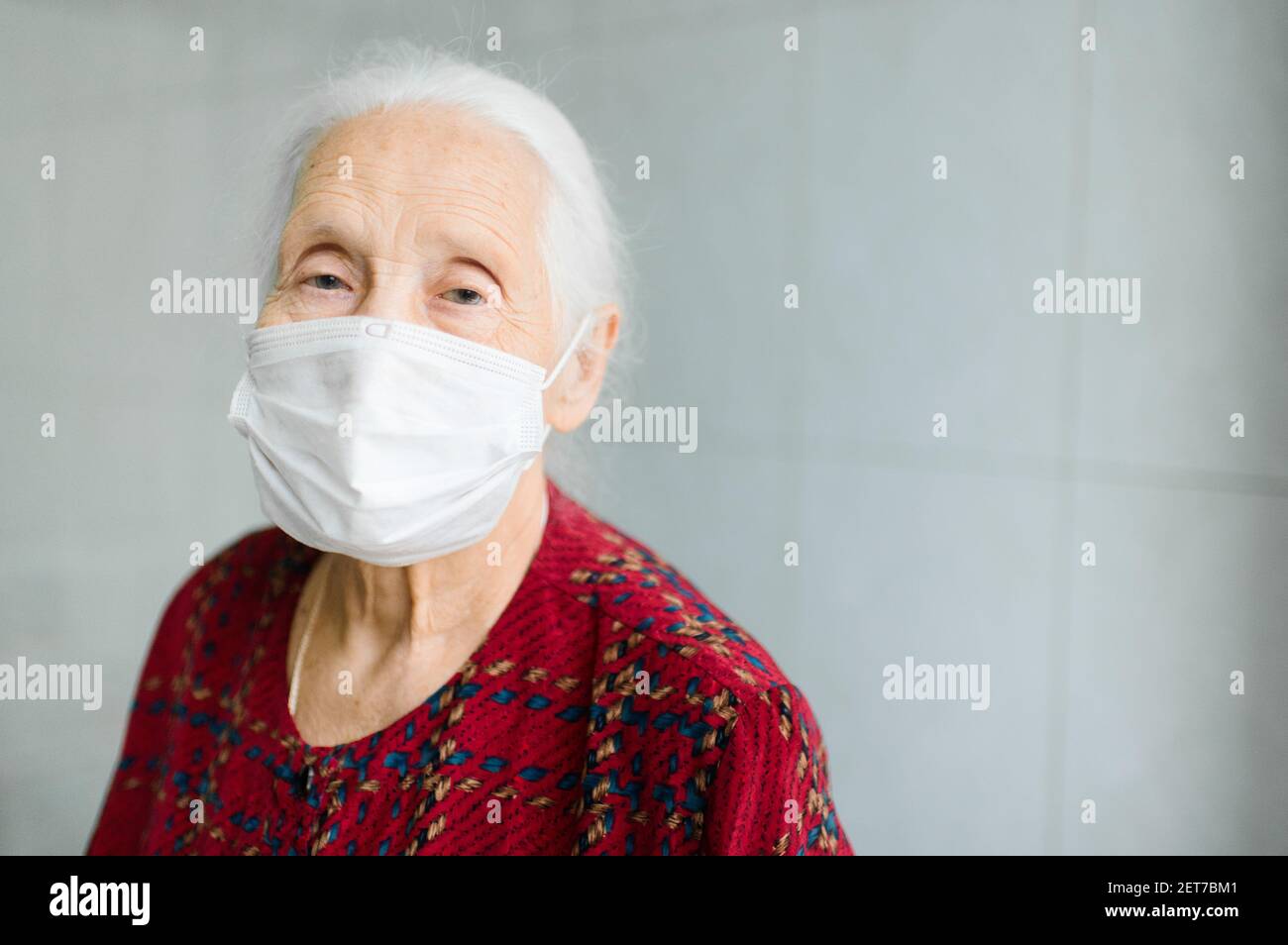 portrait of an old woman with gray hair 70-80 years old in a medical ...