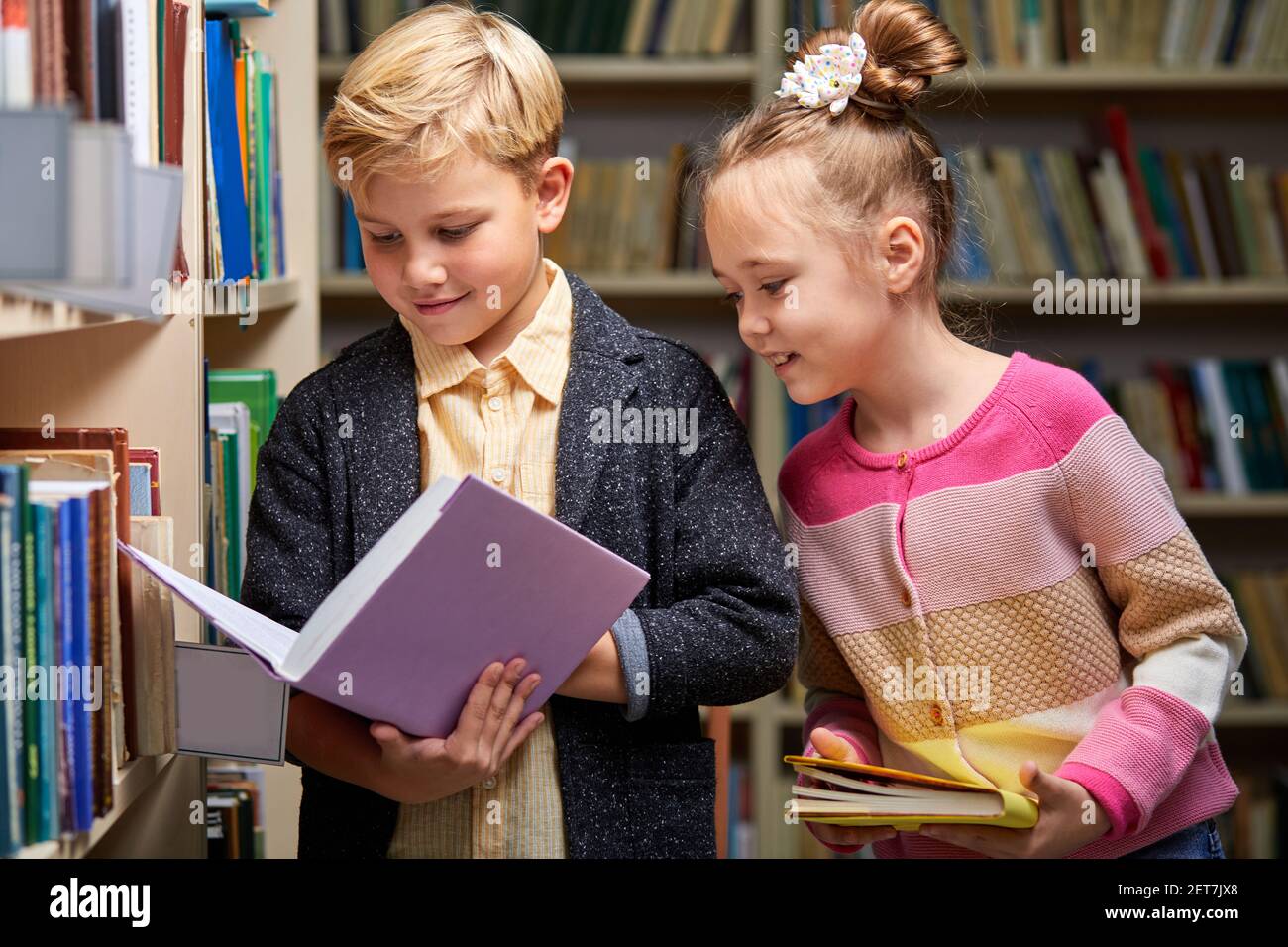 boy and girl kids reading books in library, people lifestyles and ...