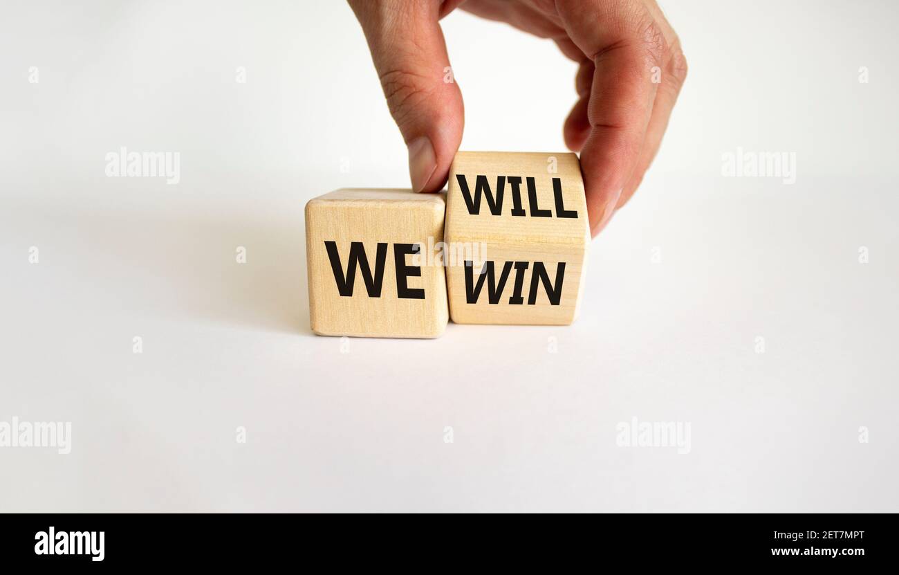 We will win symbol. Businessman turns cubes and changes words we will ...