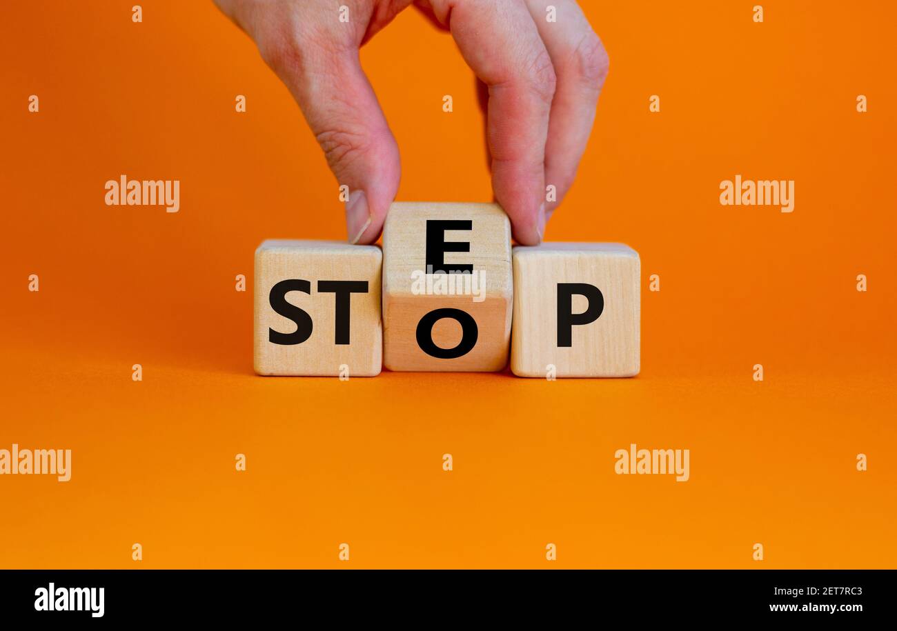 Stop or next step symbol. Businessman turns cubes and changes the word ...
