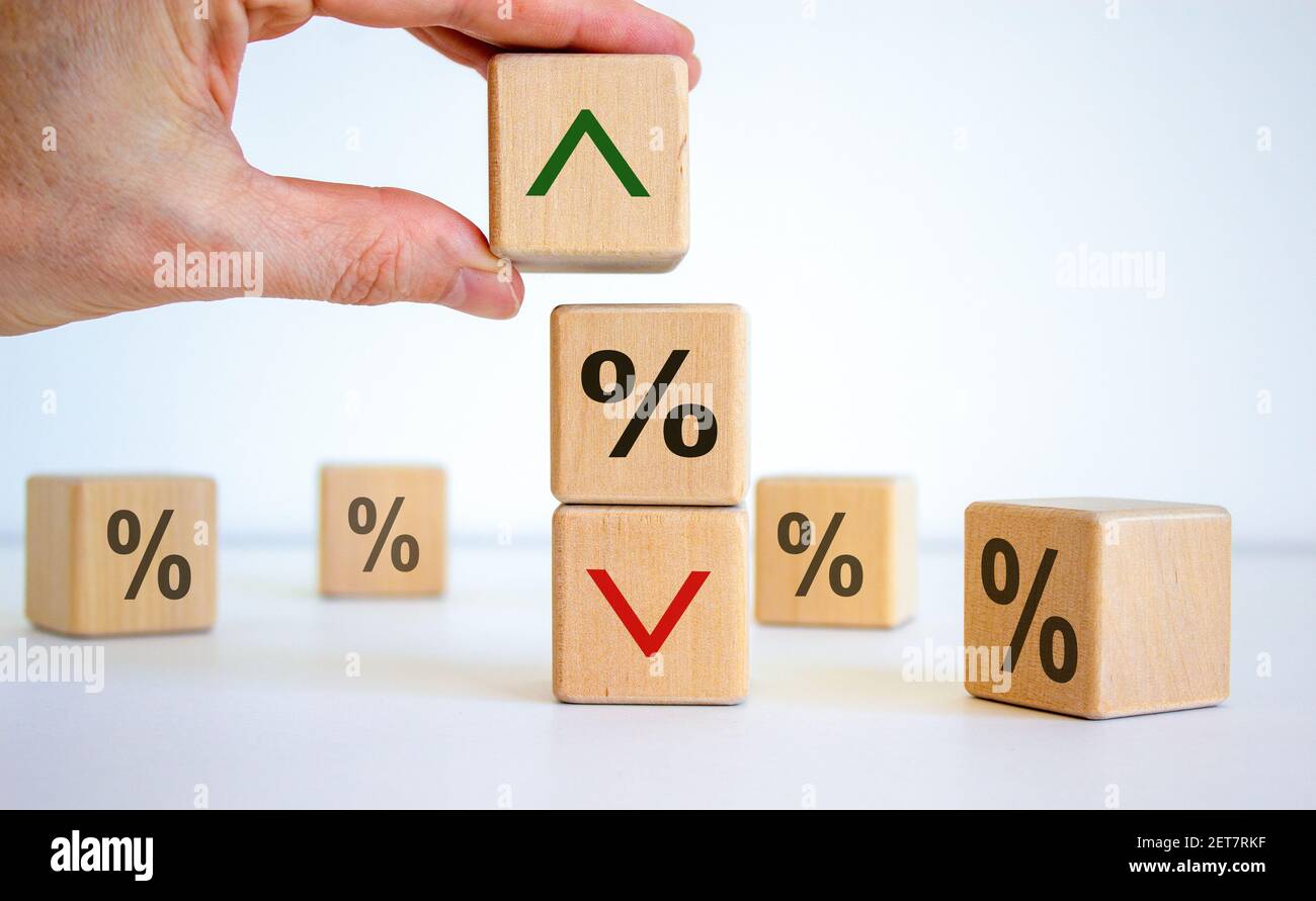 Interest rates symbol. Wooden cubes, businessman changed the direction ...