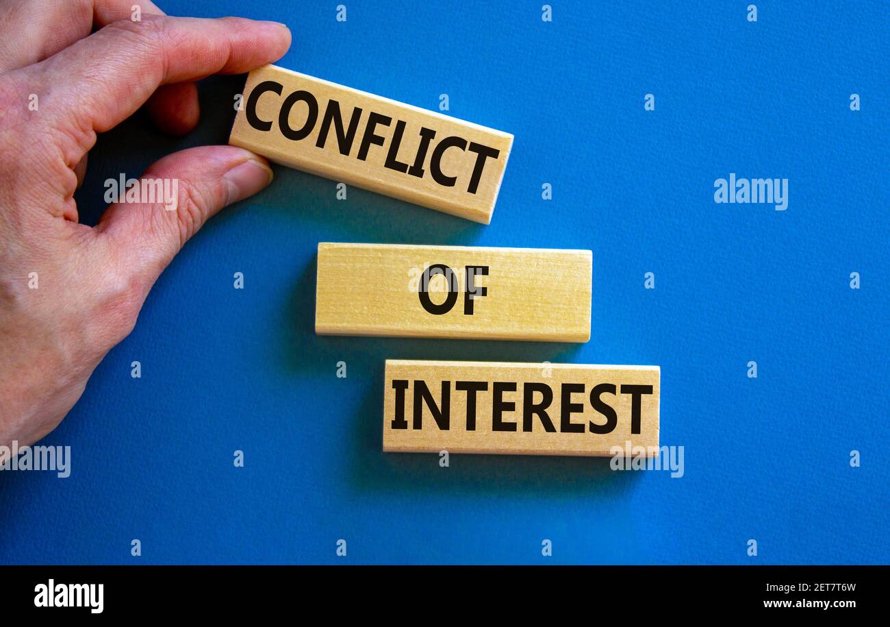 Conflict of interest symbol. Wooden blocks with words 'conflict of ...