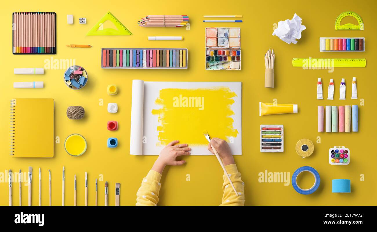 Flat lay top view of child hands with school supplies, back to school ...