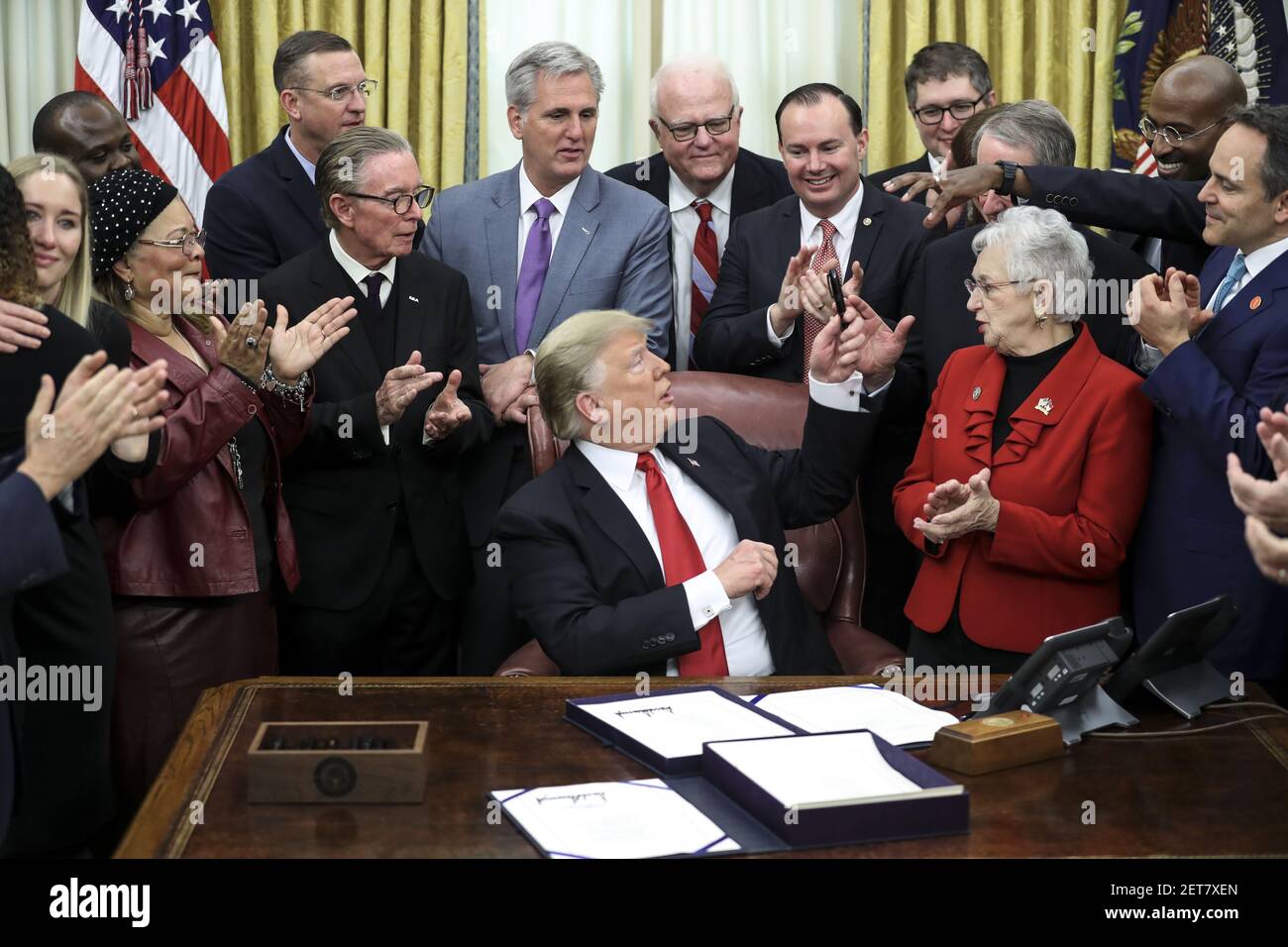 President Donald Trump gives a signing pen after he signed the First ...