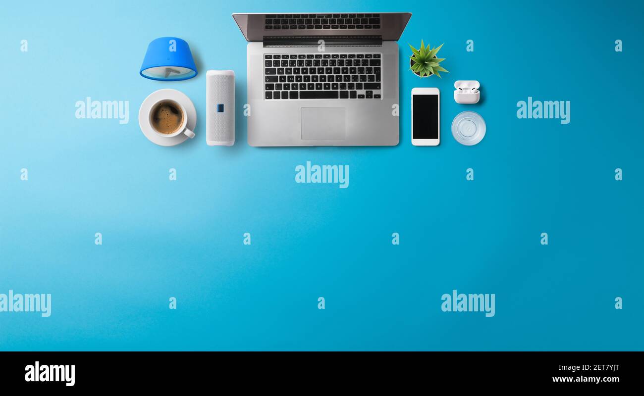 Flat lay top view office desk working space with laptop on blue ...
